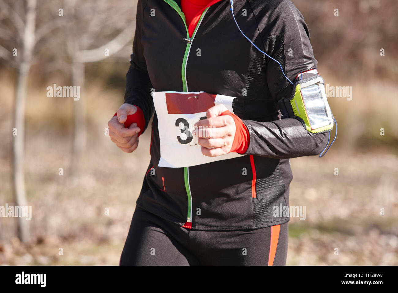 Male athletic runner on a cross country race. Outdoor circuit ...