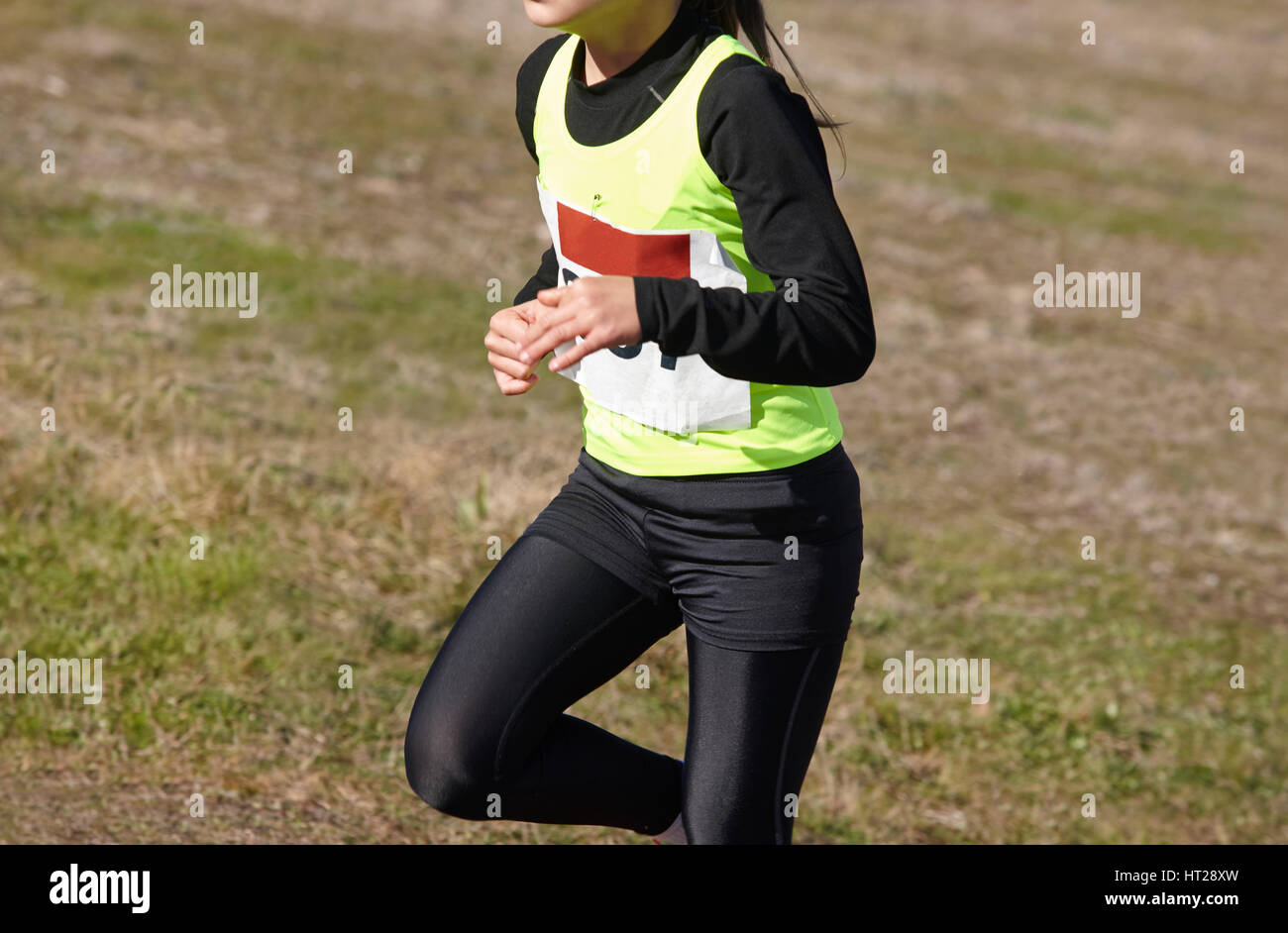 Female teen athletic runner. Cross country race. Outdoor circuit ...