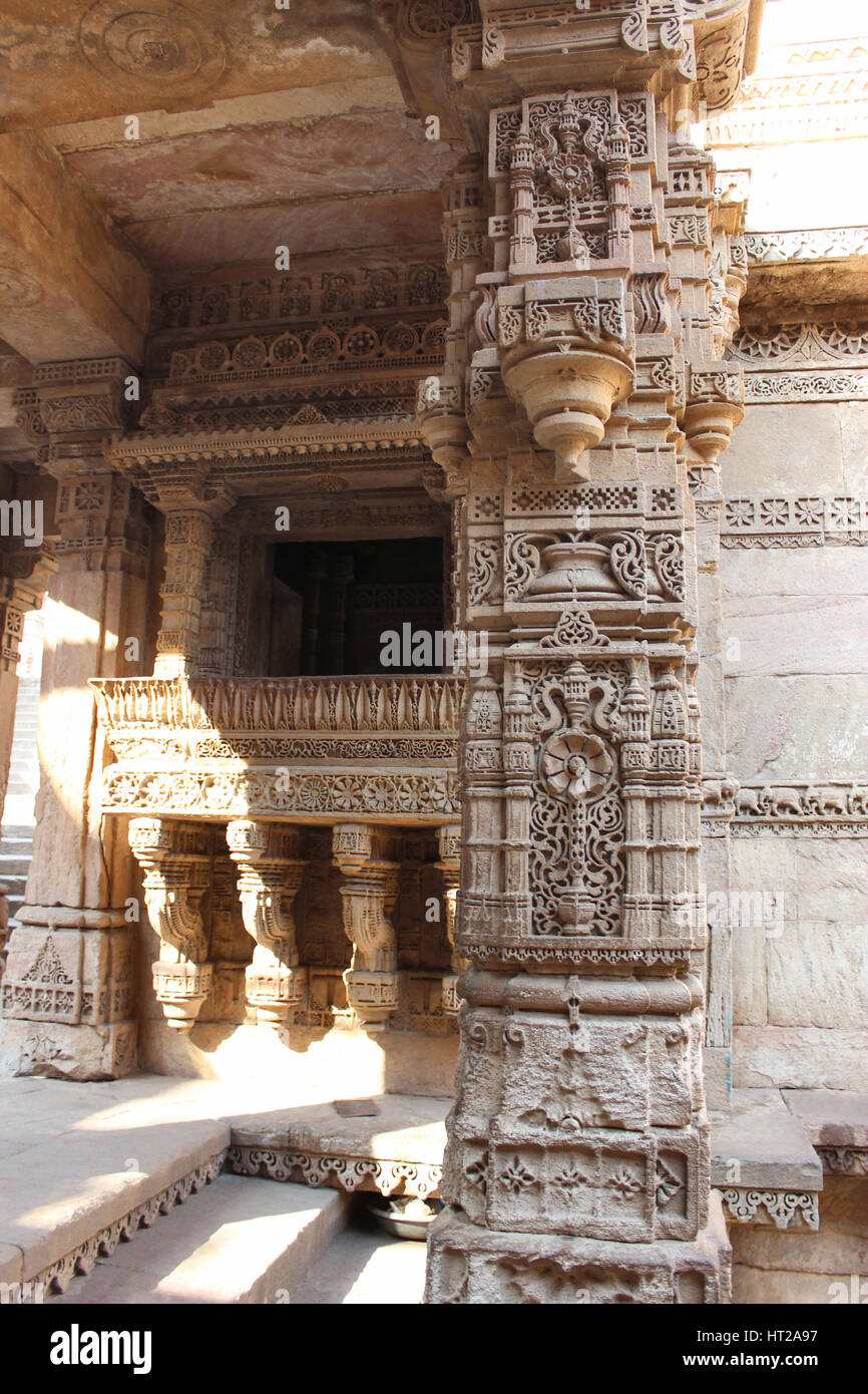 Intricate stone carving on a pillar, pilaster and entablature. Adalaj ...