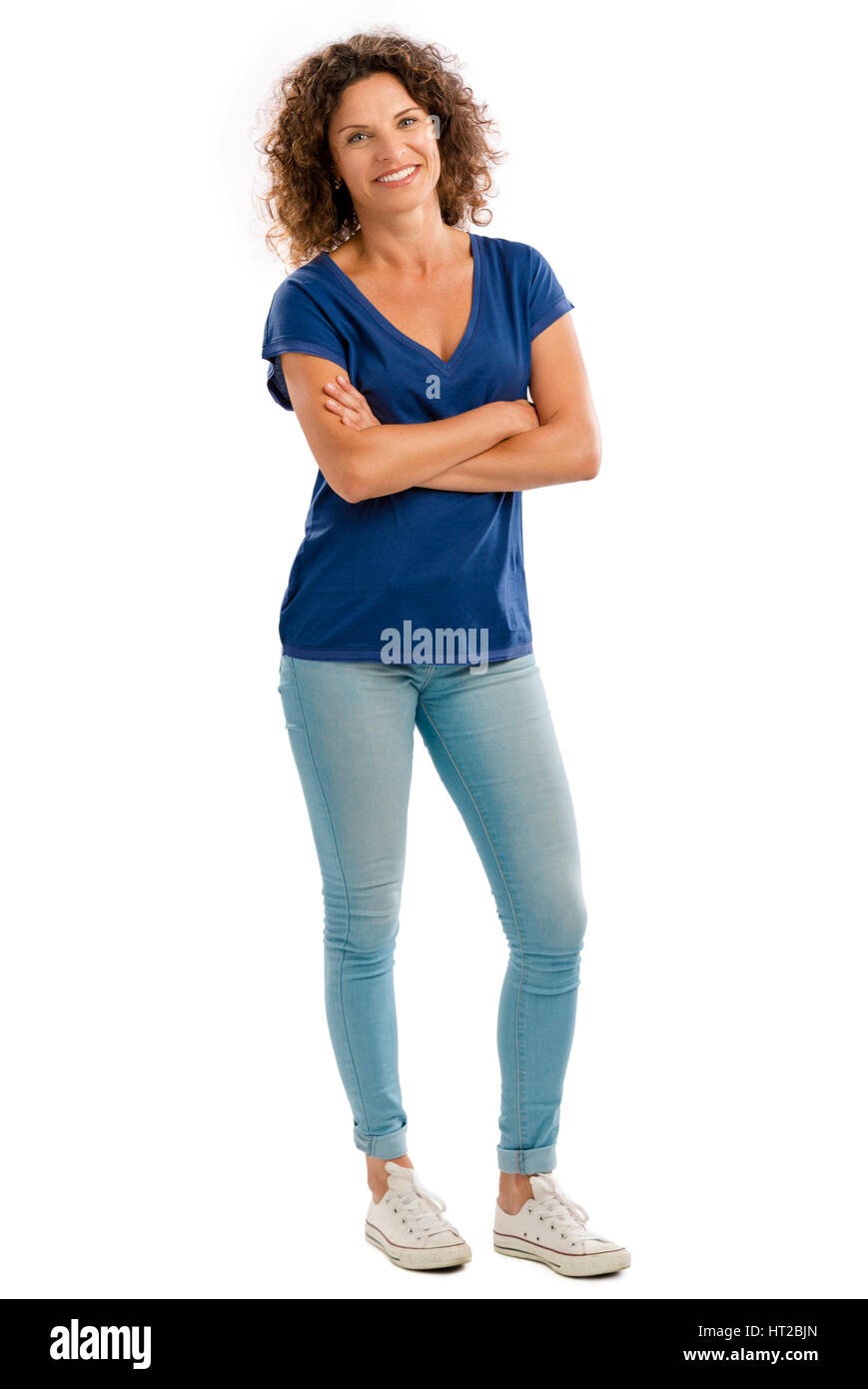 Smiling middle aged woman with arms folded, isolated on white ...