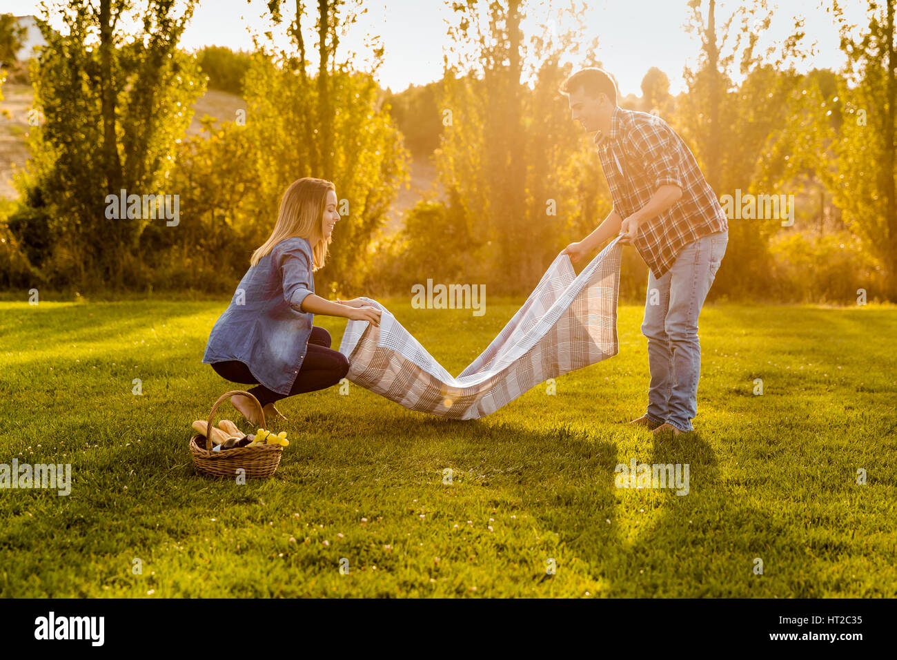 Happy couple getting ready for a picnic Stock Photo - Alamy
