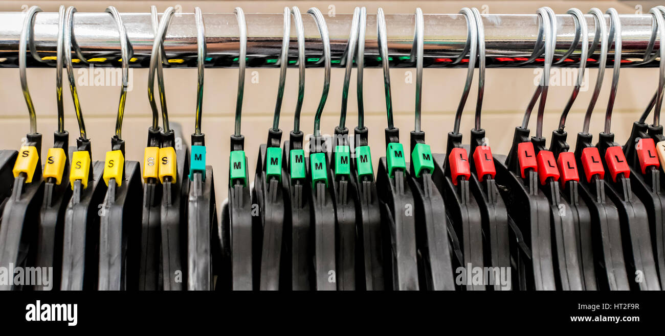 Many hangers on a rack in the store Stock Photo - Alamy