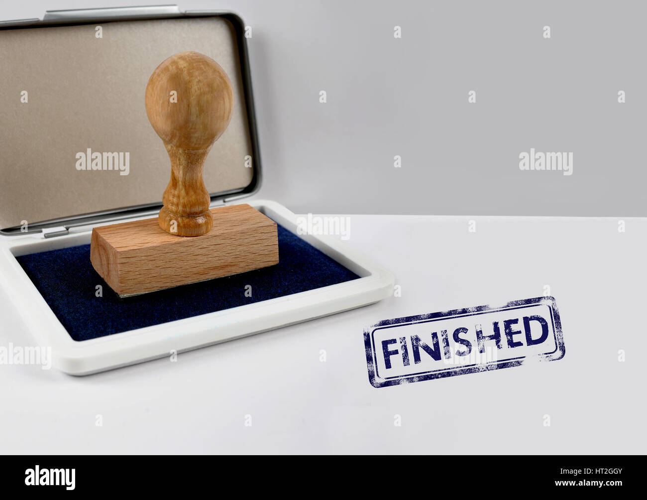 Wooden stamp on a desk FINISHED Stock Photo - Alamy