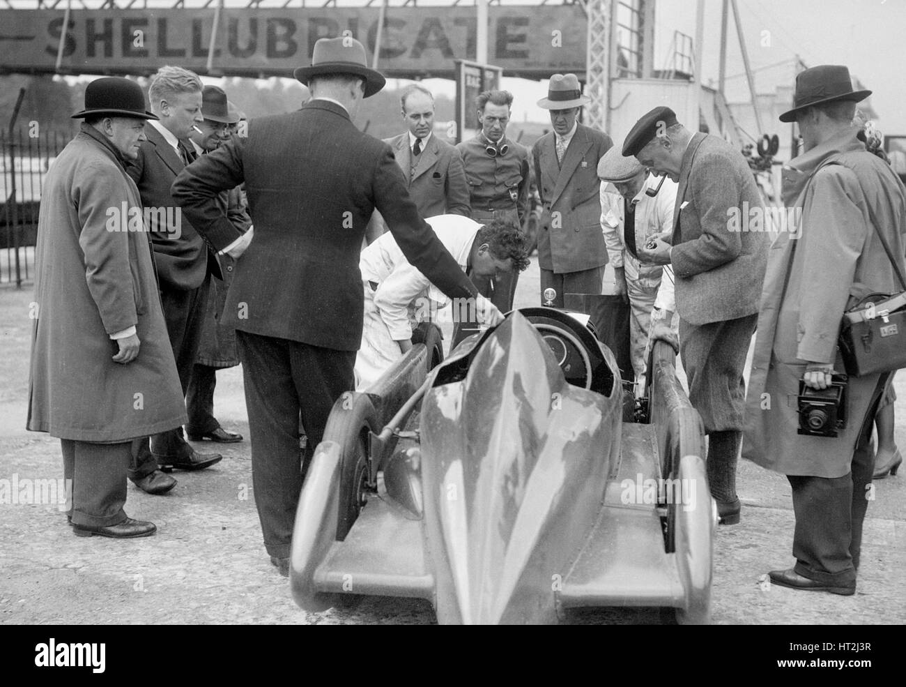 People examining Leon Cushman's Austin 7 racer at Brooklands for a ...