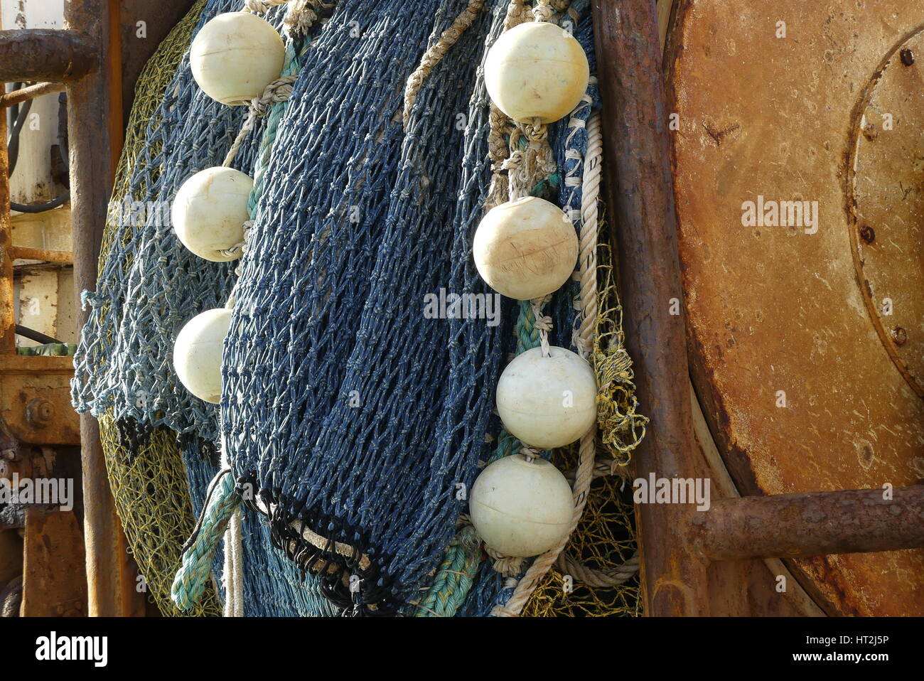 Closeup of trawl net wrapped around winch drum on the stern of a ...