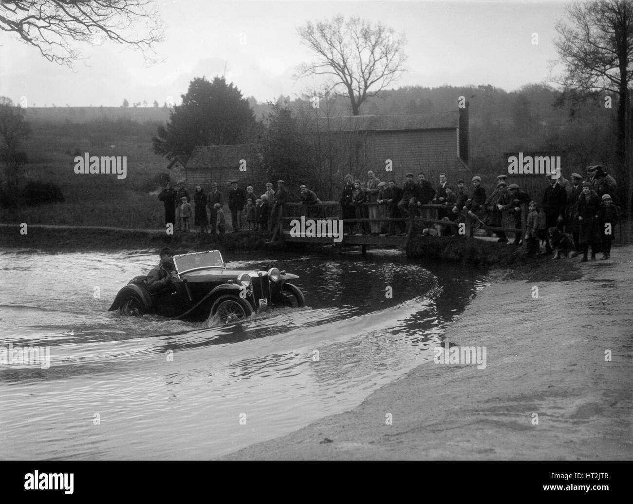 MG PA driving through a ford during a motoring trial, 1936. Artist ...