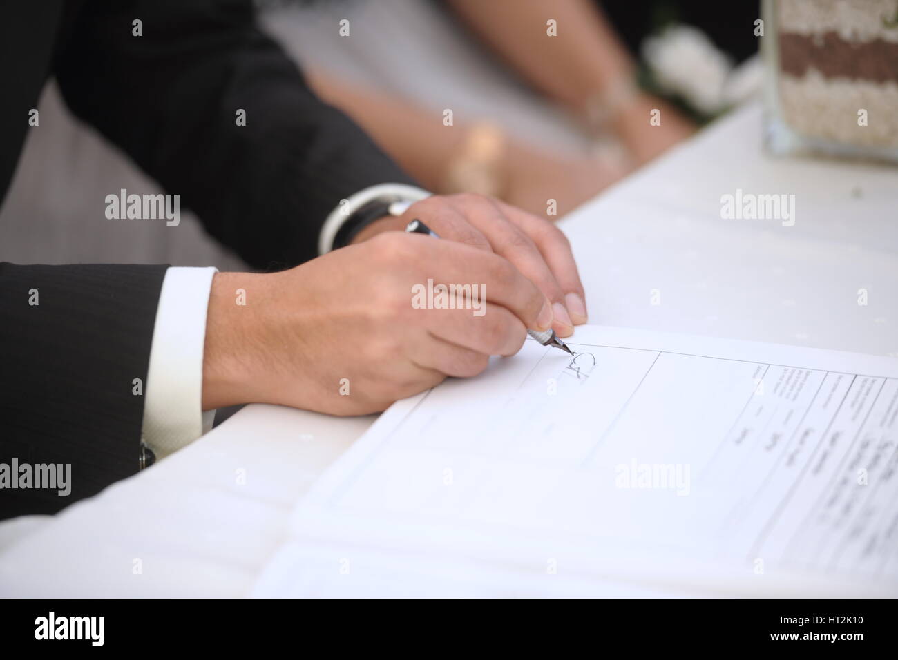 Groom signing marriage contract Stock Photo - Alamy