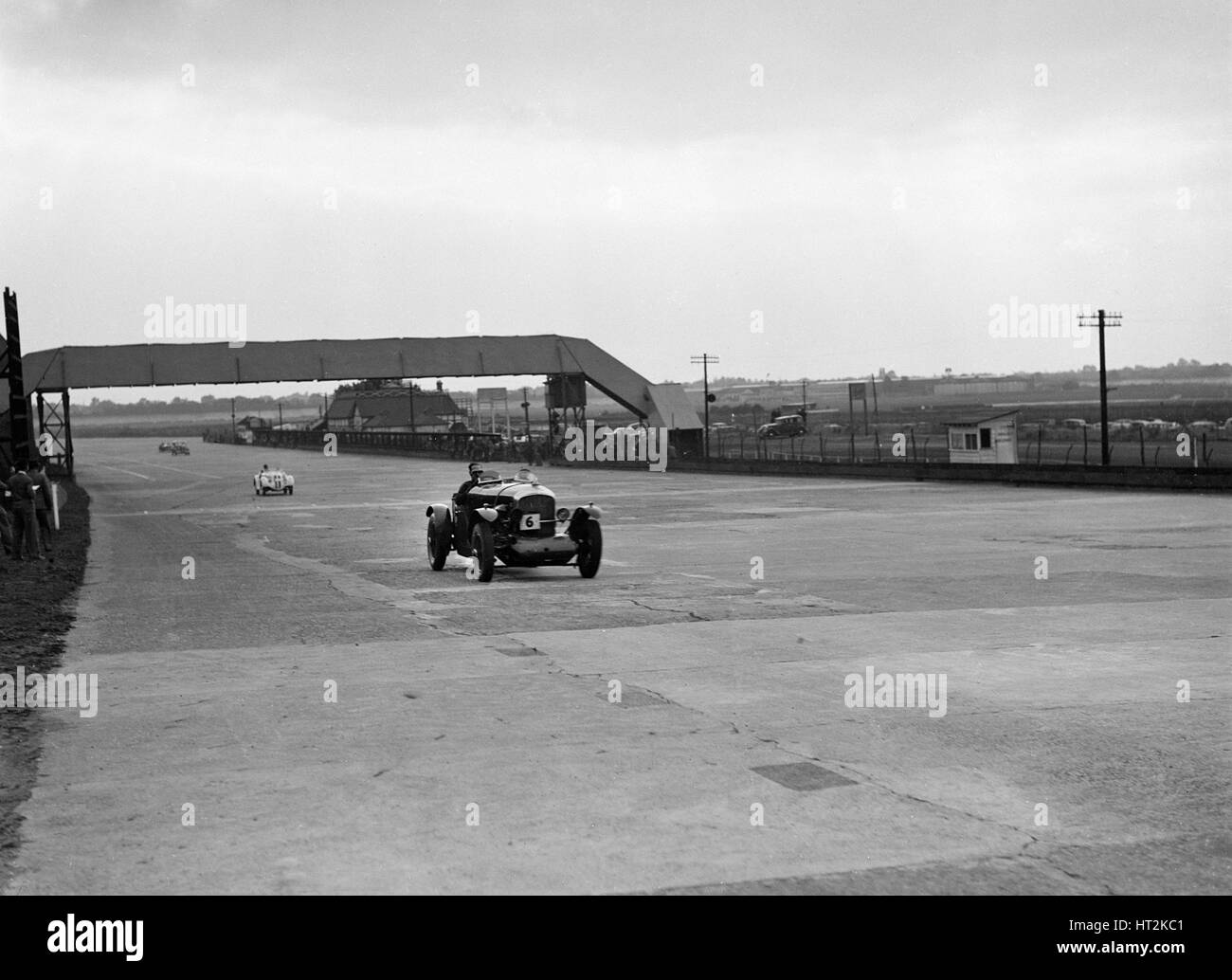 Bentley and Frazer-Nash BMW racing at Brooklands, 1938 or 1939. Artist ...
