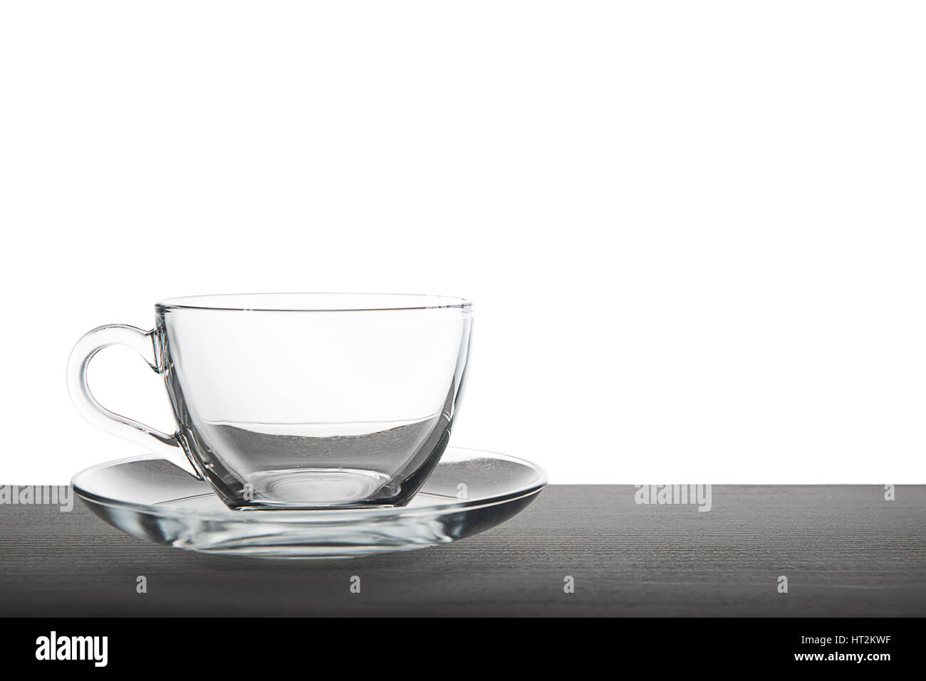 empty transparent tea cup isolated on wooden over white background ...