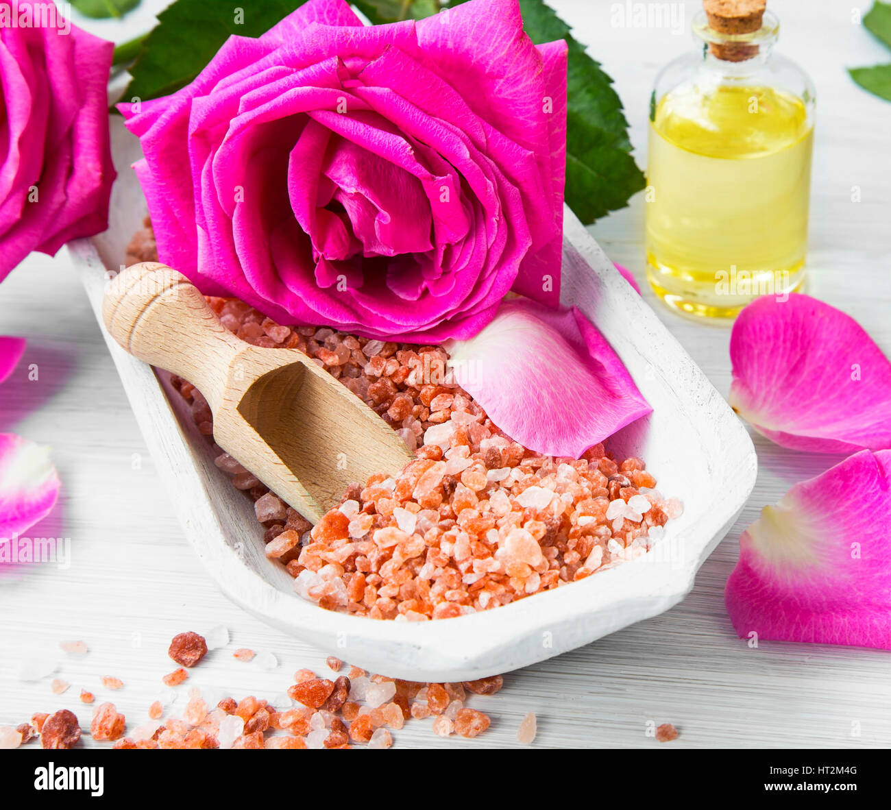 Roses spa setting with bath salt, roses flowers, bath rose oil, still ...