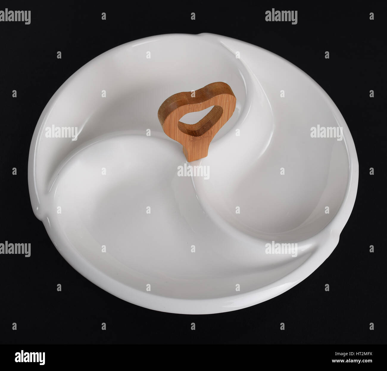 White round shallow porcelain bowl with three compartments, top view ...