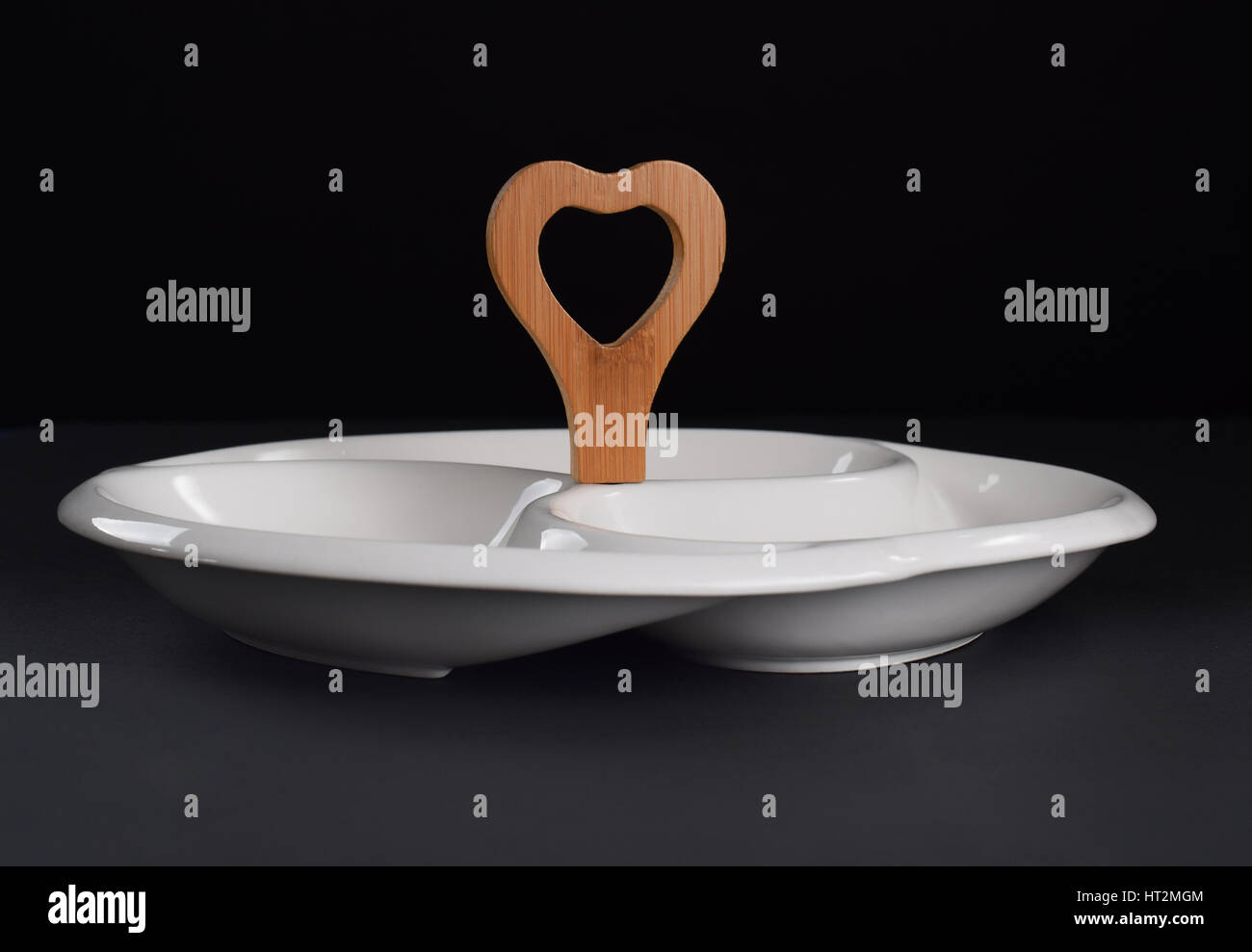 White round shallow porcelain bowl with three compartments, front view ...