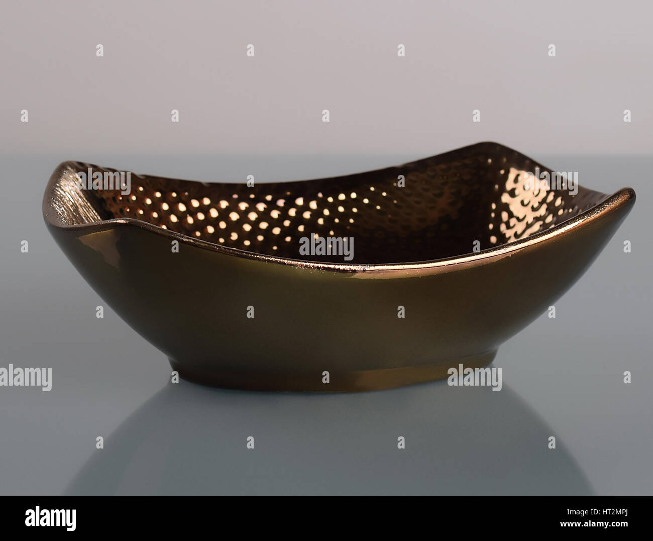 Golden deep ceramic bowl, front view Stock Photo - Alamy
