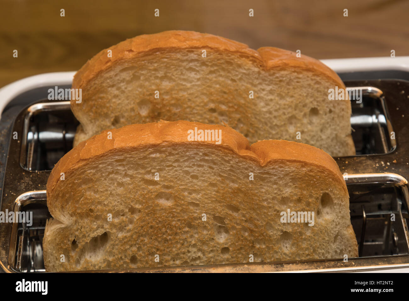 Two newly toasted white bread slices in a toaster Stock Photo - Alamy