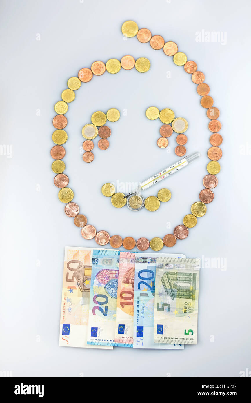Sad sick smiley made of Euro coins with a blanket of Euro banknotes ...