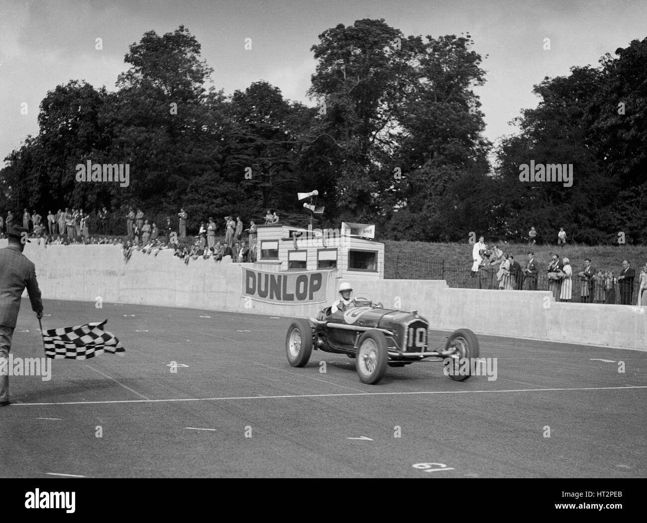 Alfa Romeo of Kenneth Evans taking the chequered flag at Crystal Palace ...