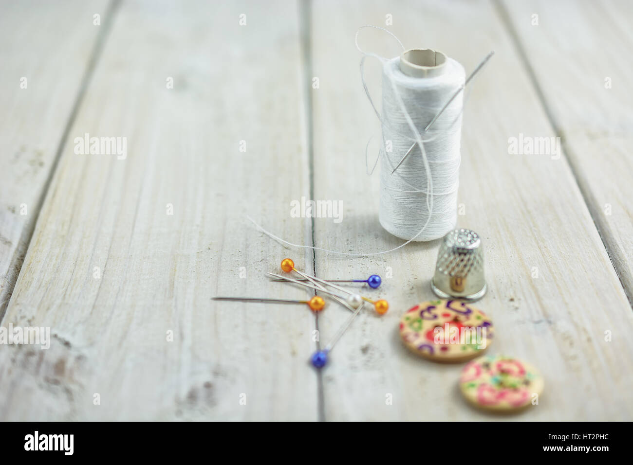 sewing tools on wooden background Stock Photo - Alamy