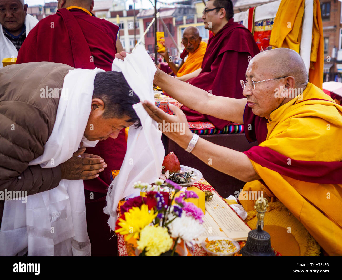 Kathmandu, Nepal. 7th Mar, 2017. A Buddhist monk places a prayer shawl ...