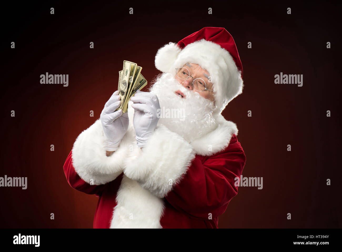 Santa Claus counting dollar banknotes Stock Photo - Alamy