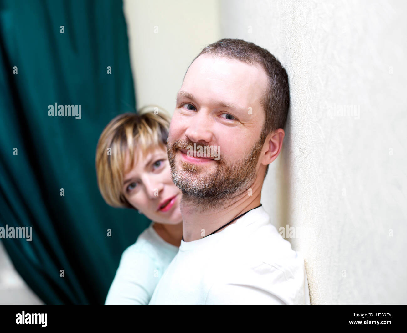 Beautiful couple with a pleasant, happy look on their faces, indoor ...
