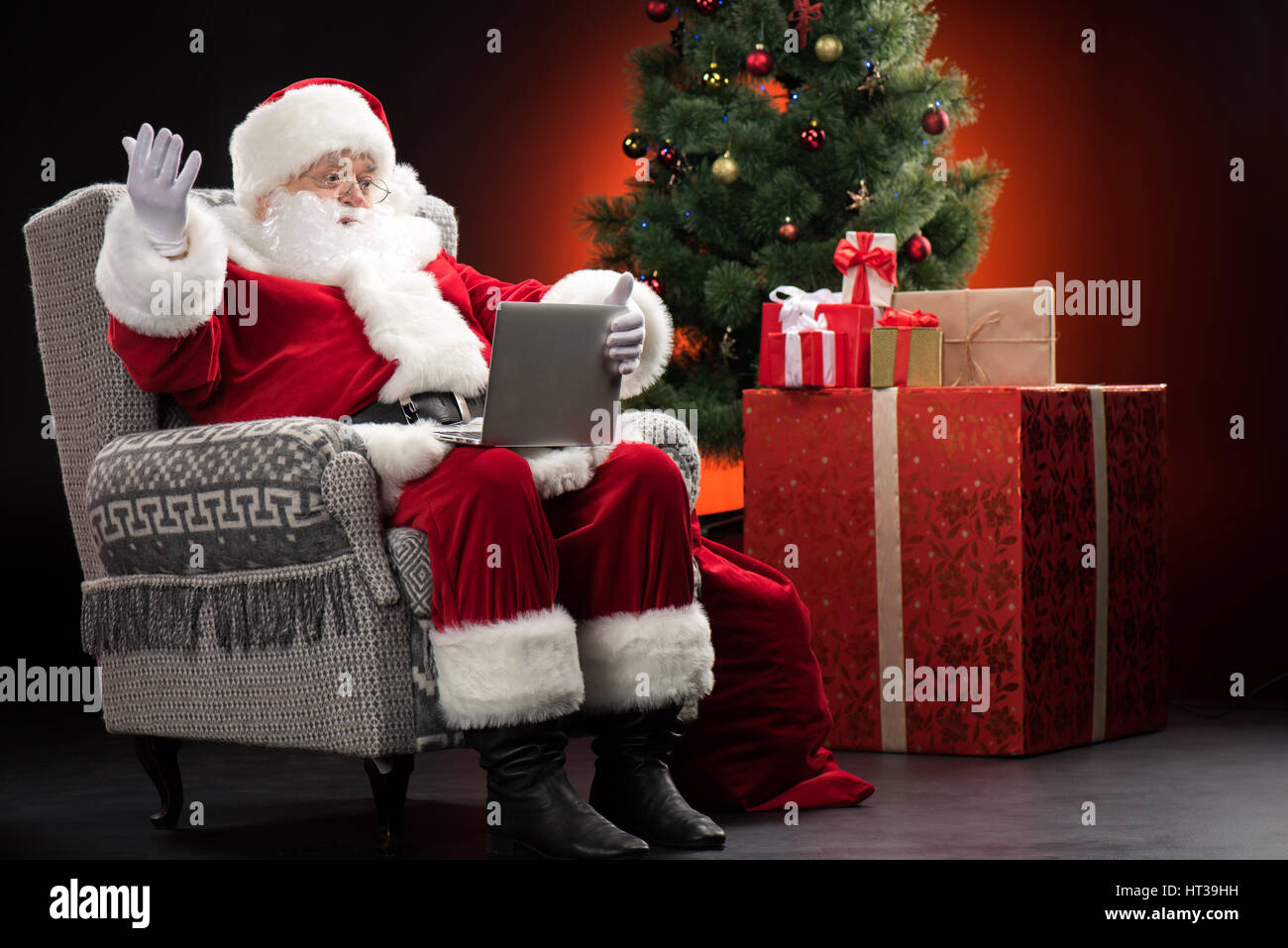 Santa Claus using laptop and gesturing Stock Photo - Alamy