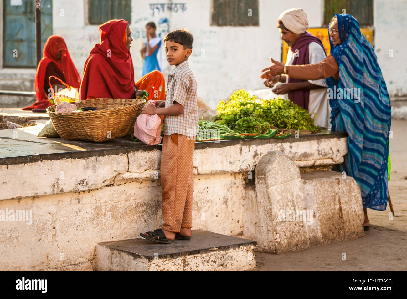 Rural India: A boy peacefully shops at a village square market stall ...