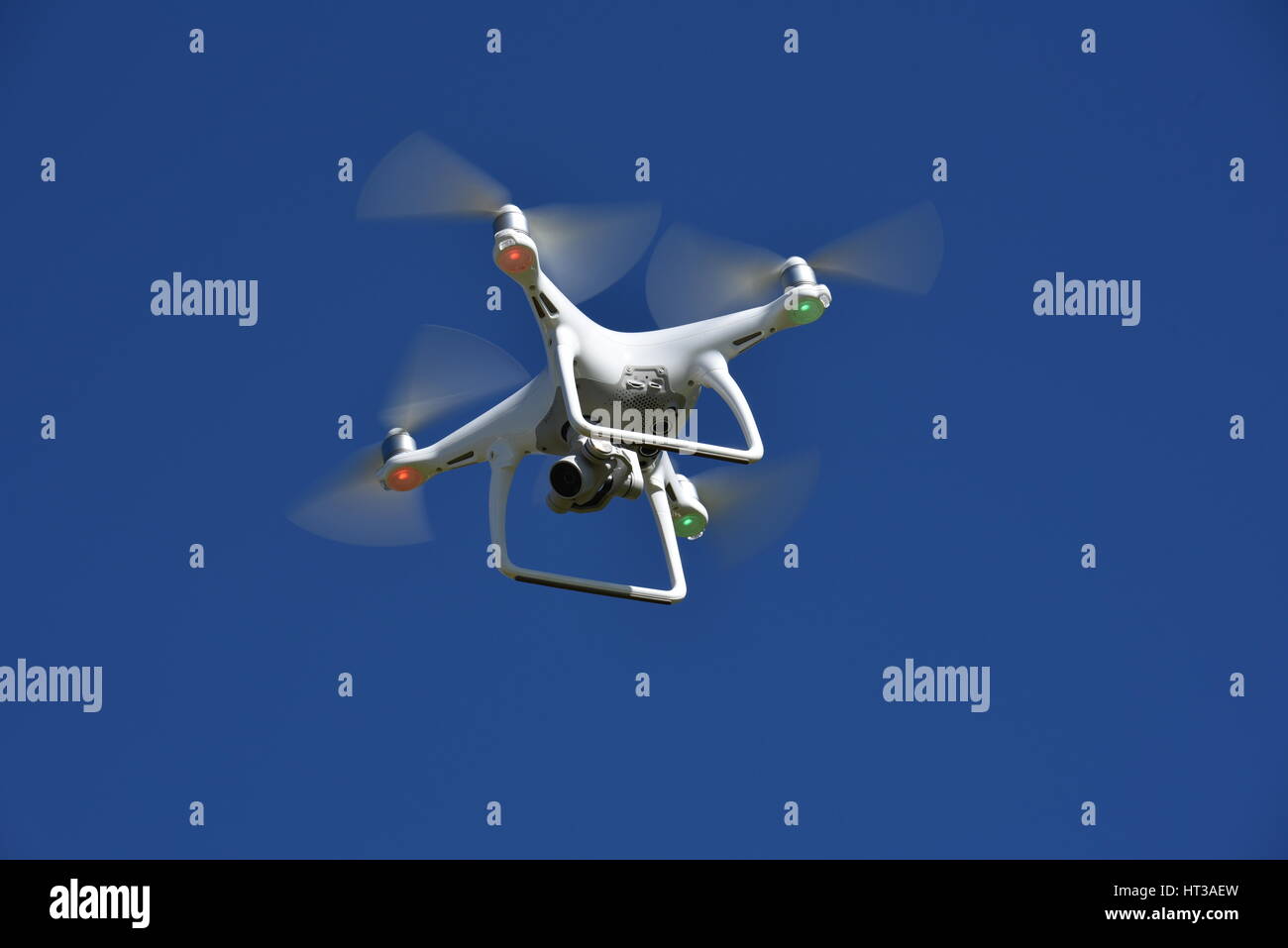 A view from below of a flying DJI Phantom 4 Drone with a gimbal and ...