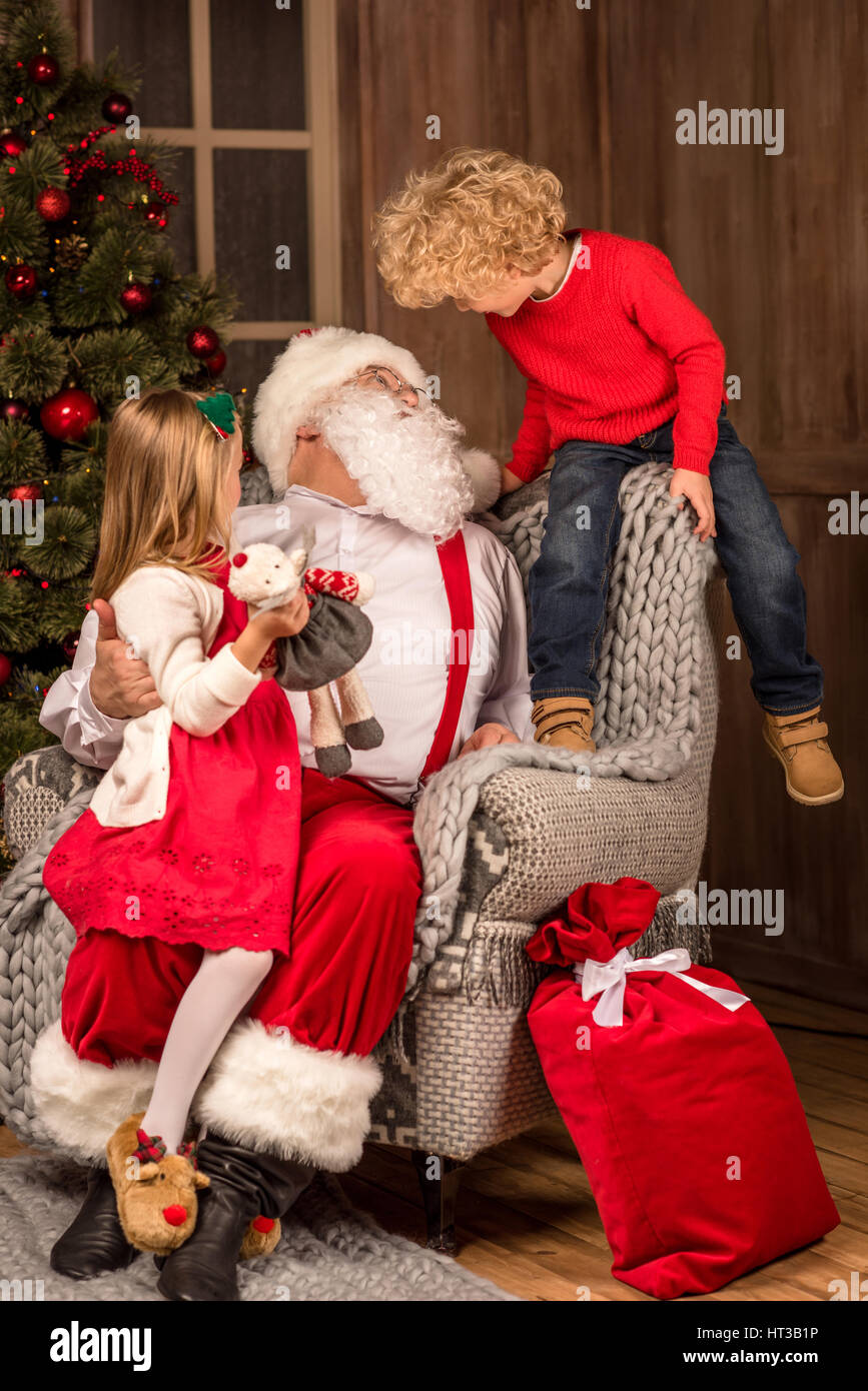 Santa Claus with happy children Stock Photo - Alamy