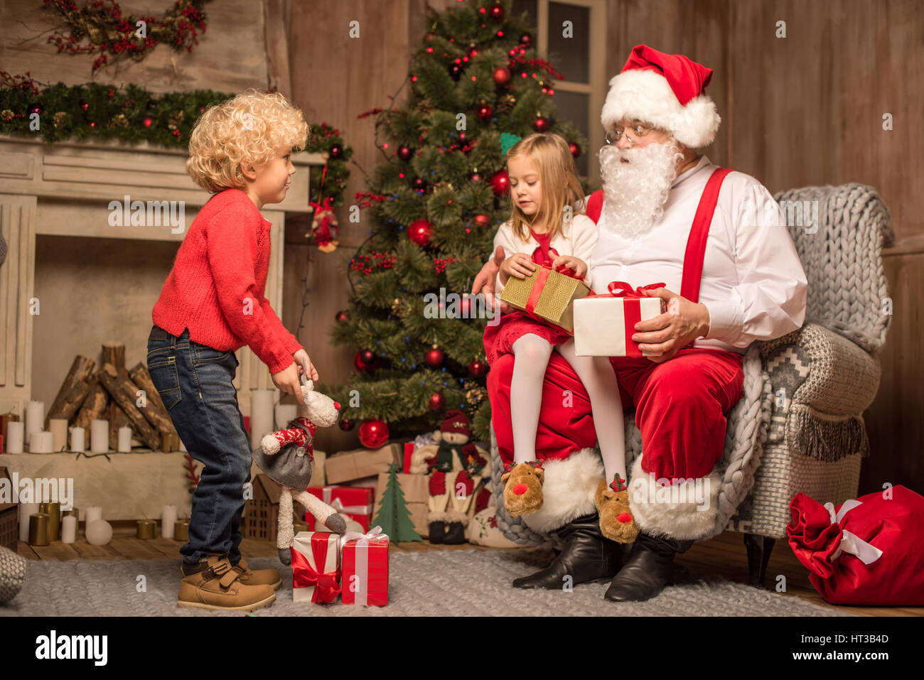 Santa Claus with happy children Stock Photo - Alamy
