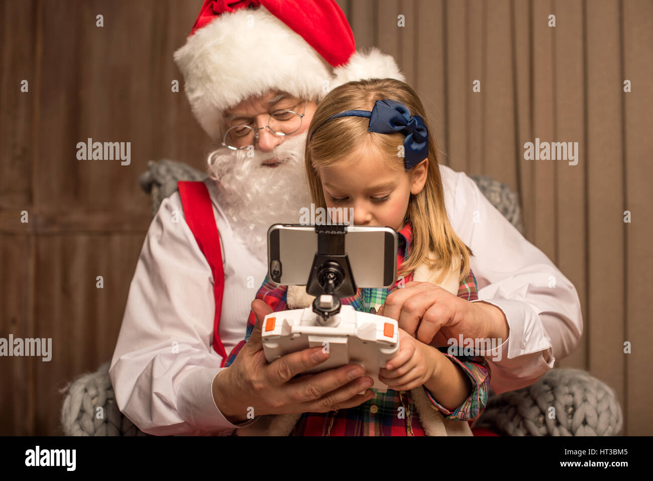 Santa with kid using hexacopter drone Stock Photo - Alamy