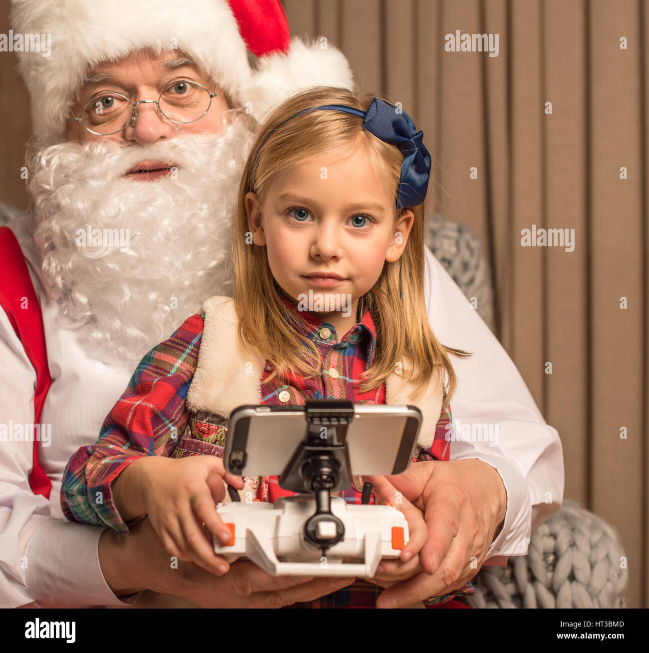 Santa Claus with kid looking at camera Stock Photo - Alamy