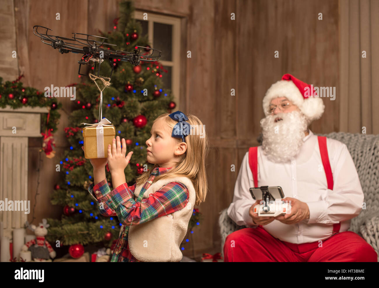 Santa with kid using hexacopter drone Stock Photo - Alamy
