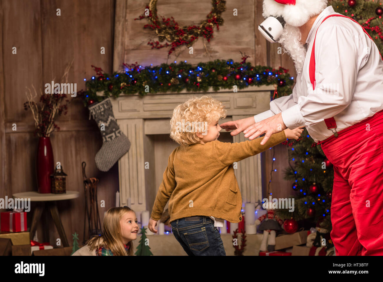 Santa Claus playing with children Stock Photo - Alamy