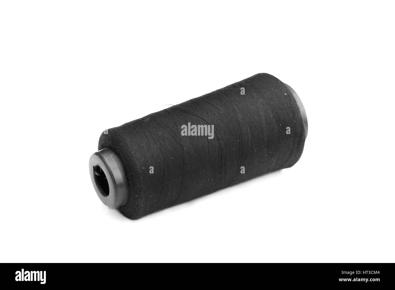 Black bobbin of thread on white background Stock Photo - Alamy