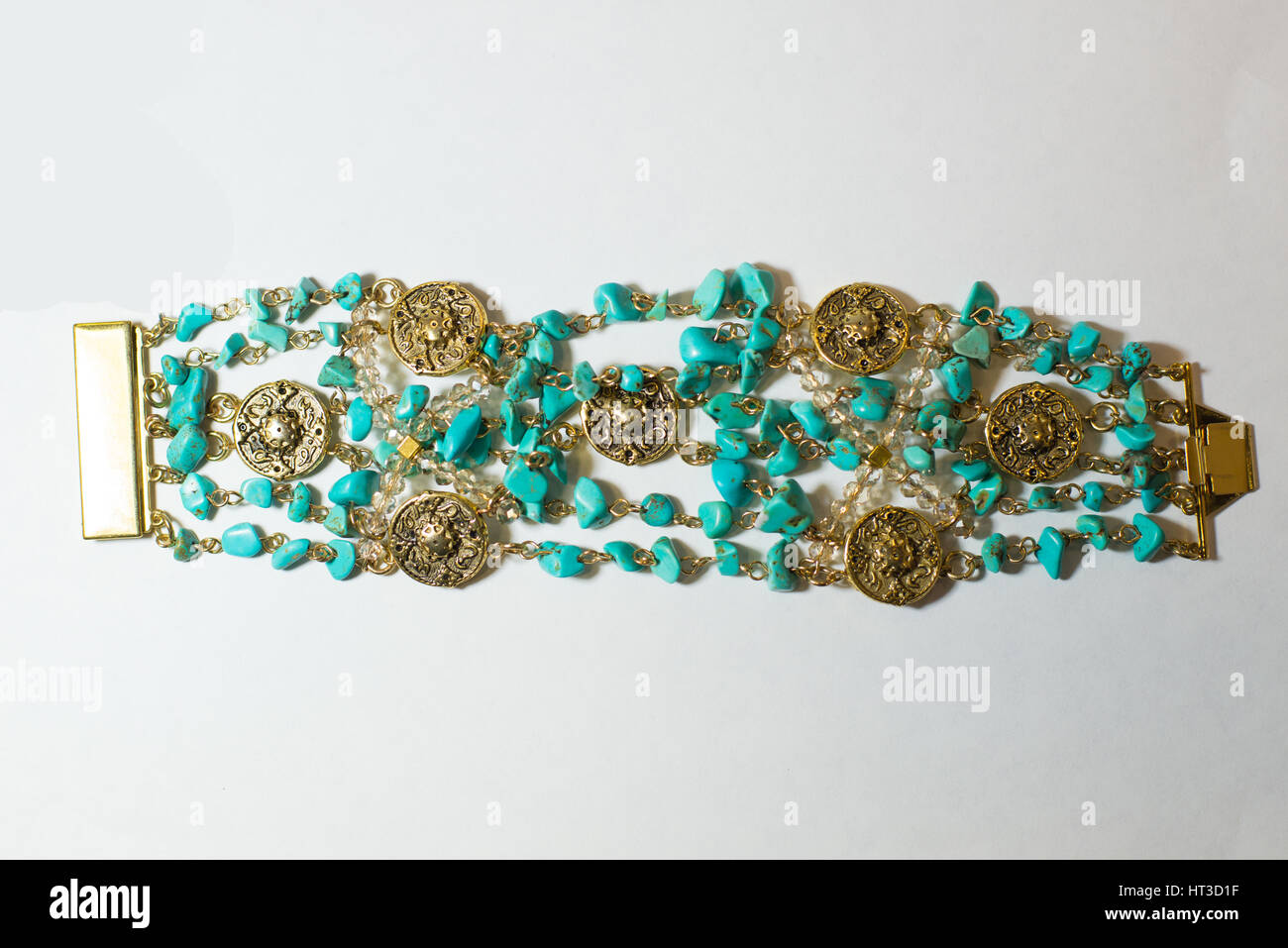 Ethnic bracelet hand white background plastic multi-colored stones ...