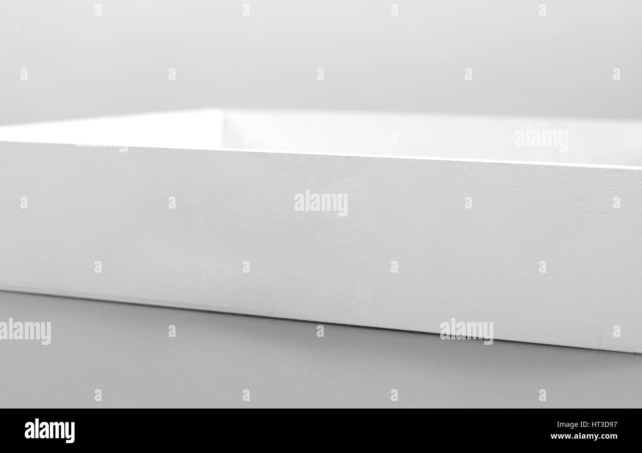 Detail of white wooden tray on gray background Stock Photo - Alamy