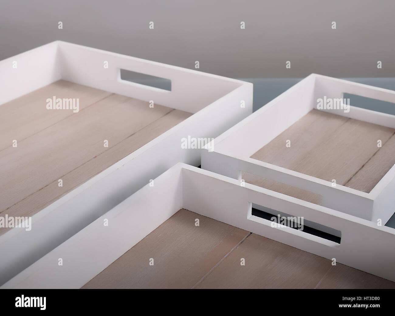 White wooden trays on gray background Stock Photo - Alamy