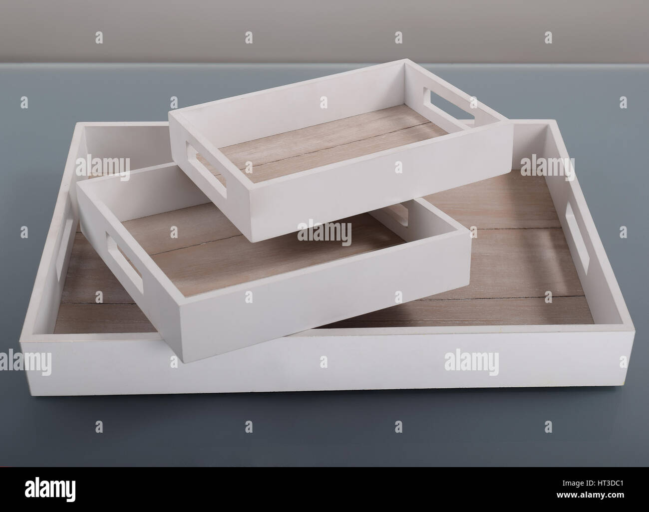 White wooden trays on gray background Stock Photo - Alamy
