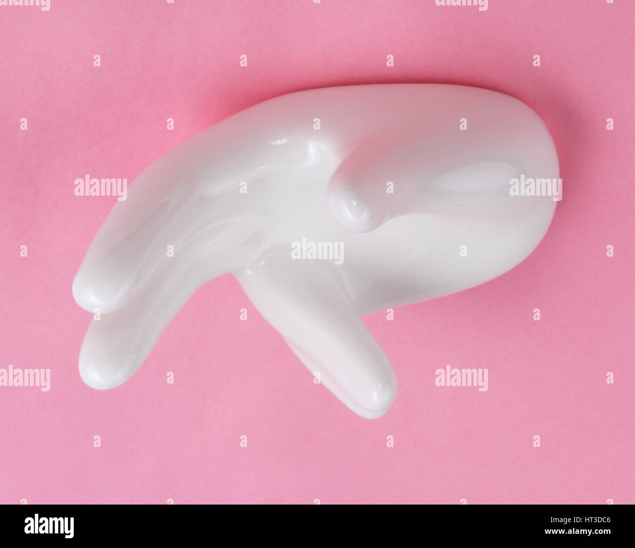 Ceramic stand with hand shape on pink background Stock Photo - Alamy