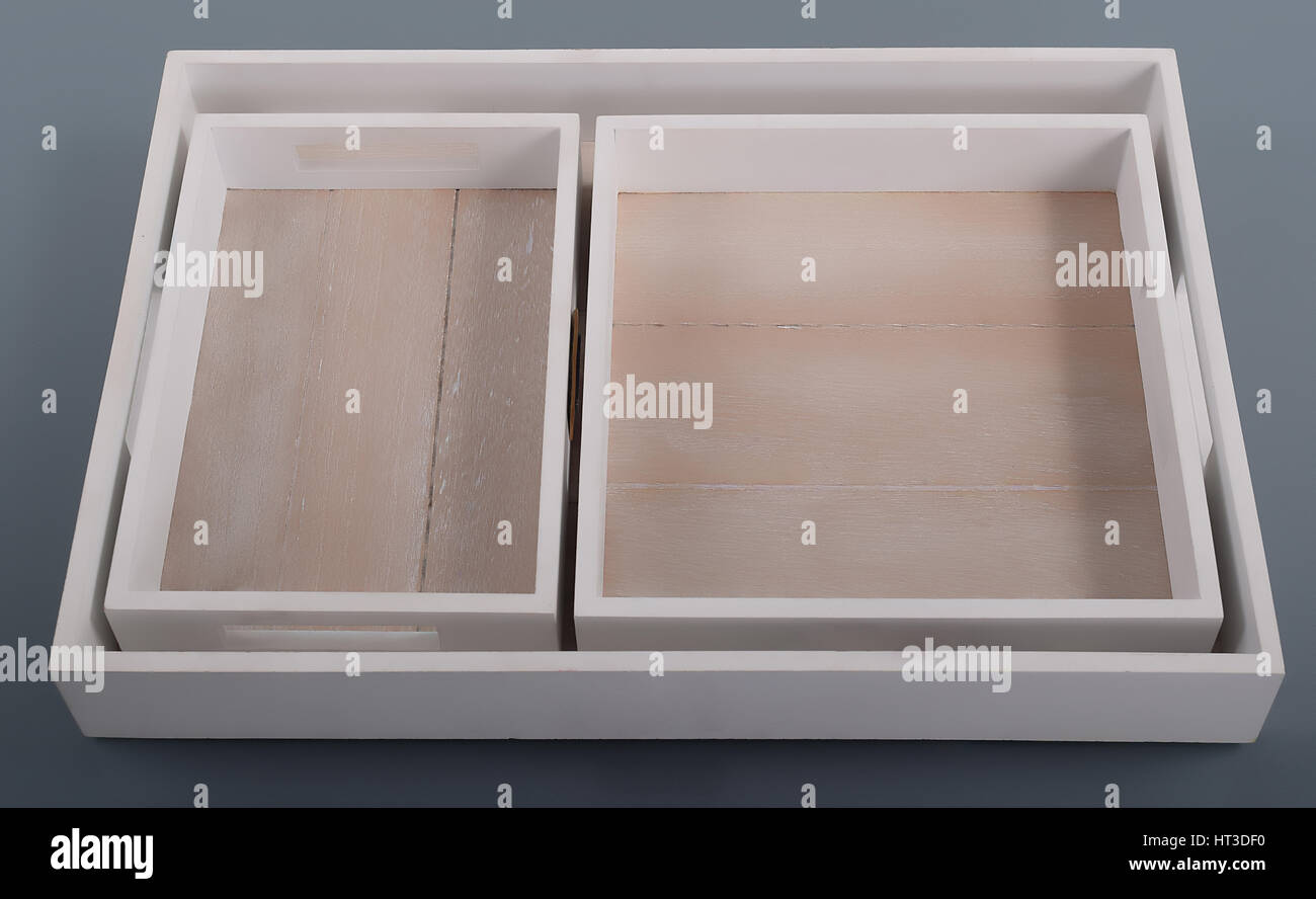 White wooden trays on gray background Stock Photo - Alamy