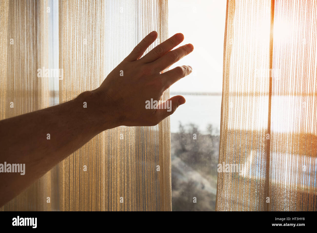 Hand opens curtain window hi-res stock photography and images - Alamy