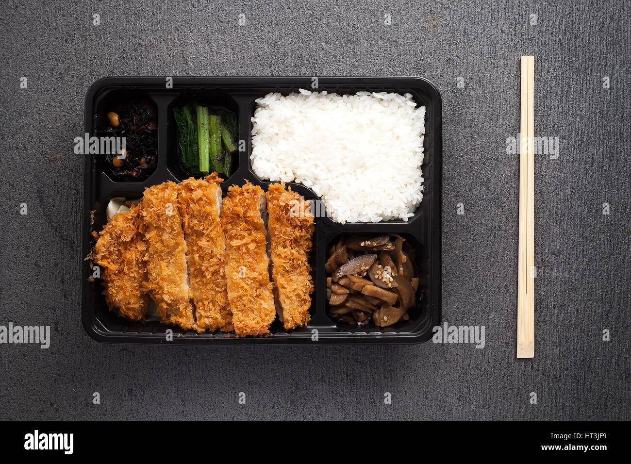 Japanese food tonkatsu rice and vegetable take away on table background ...