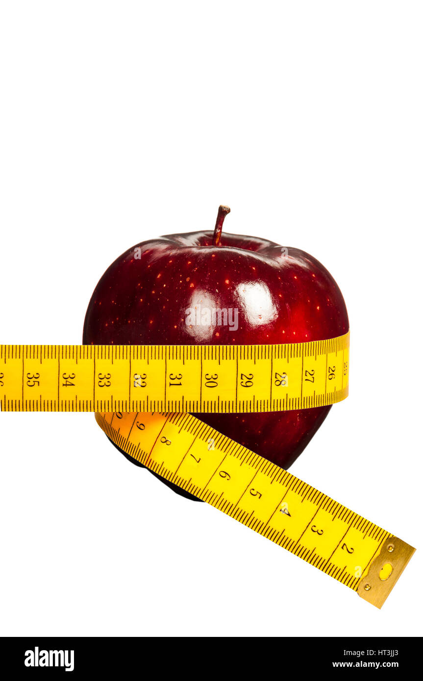 yellow metric tape around an red apple on white background Stock Photo ...