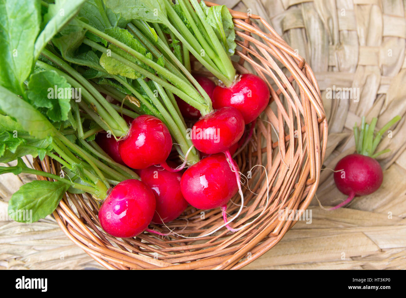 Bunch of radishes with leaves on a wicker table Stock Photo - Alamy