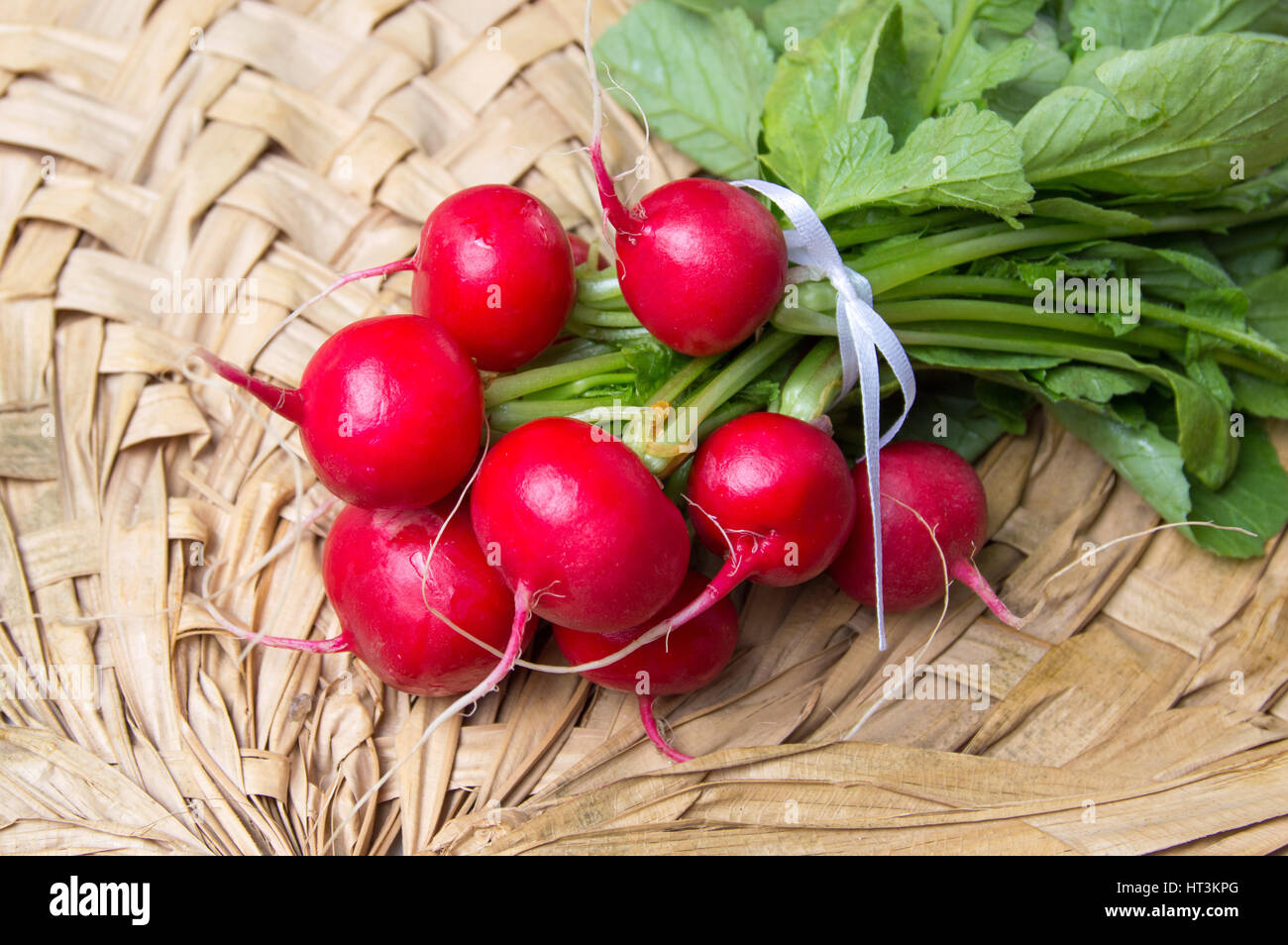 Bunch of radishes with leaves on a wicker table Stock Photo - Alamy