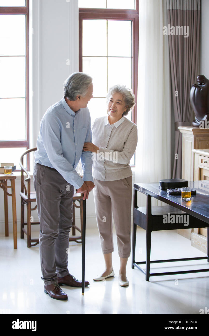 Senior woman taking care of husband Stock Photo - Alamy