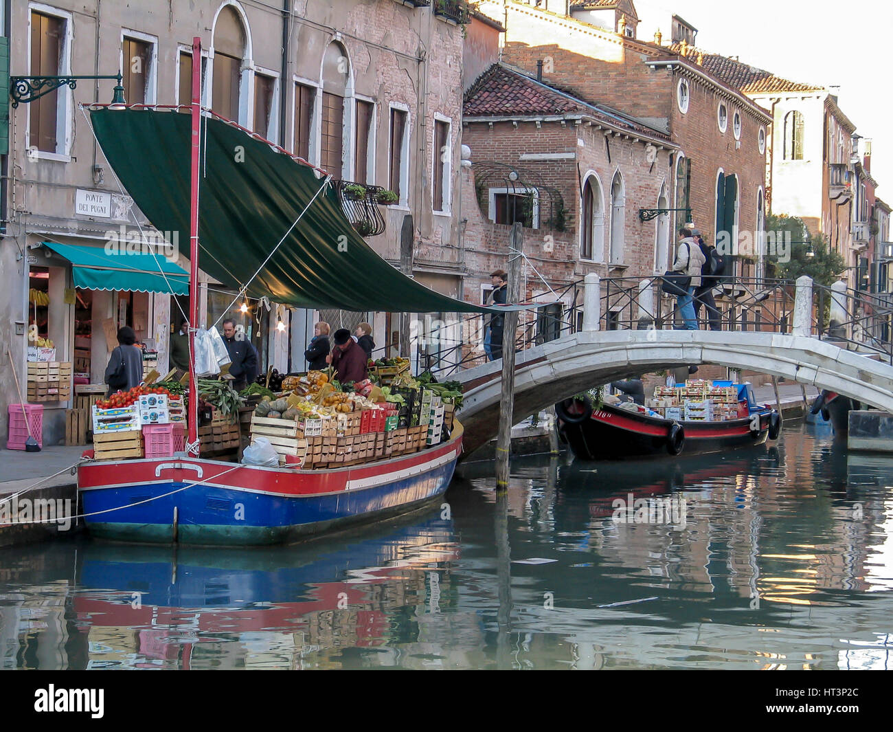 Vibrant market on the Ponte dei Pugni canal in Venice showcasing fresh ...