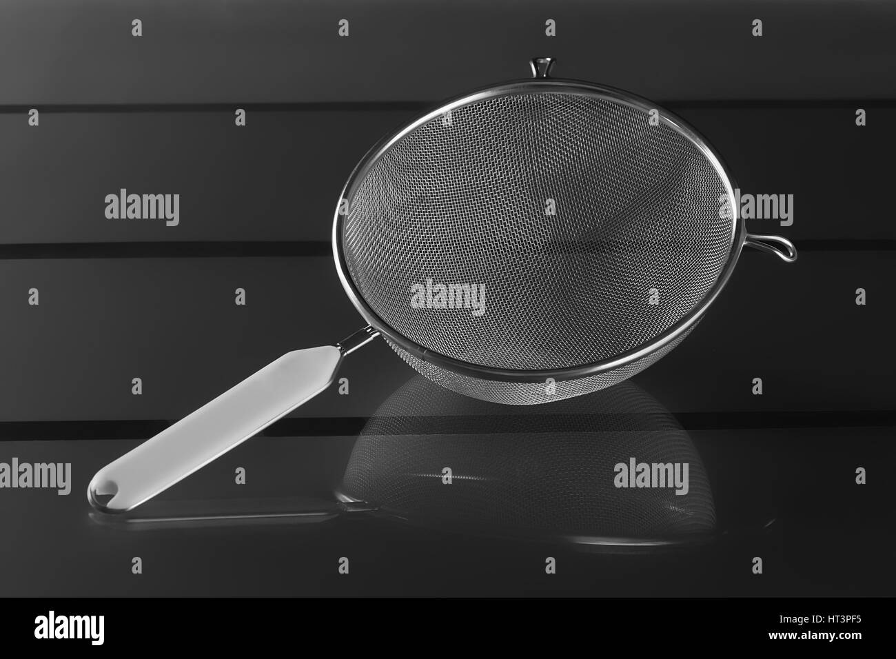 Metallic strainer with plastic handle, a modern kitchen utensil Stock ...