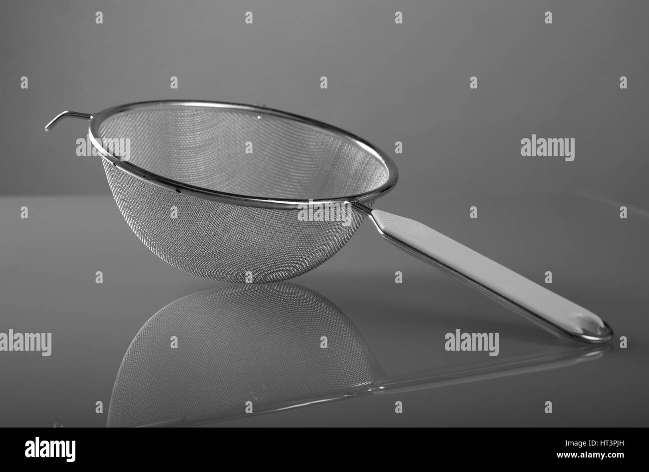 Metallic strainer with plastic handle, a modern kitchen utensil Stock ...