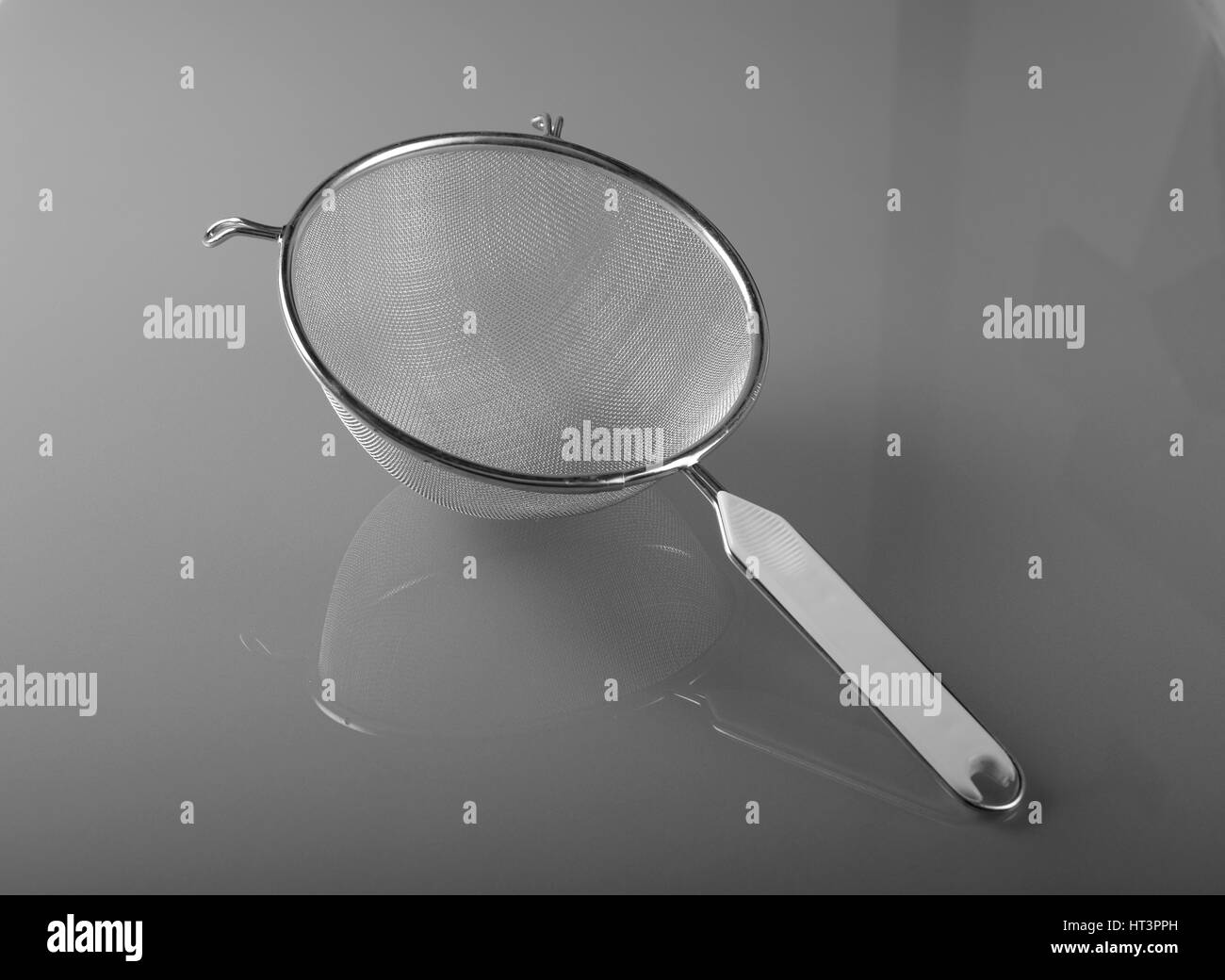 Metallic strainer with plastic handle, a modern kitchen utensil Stock ...